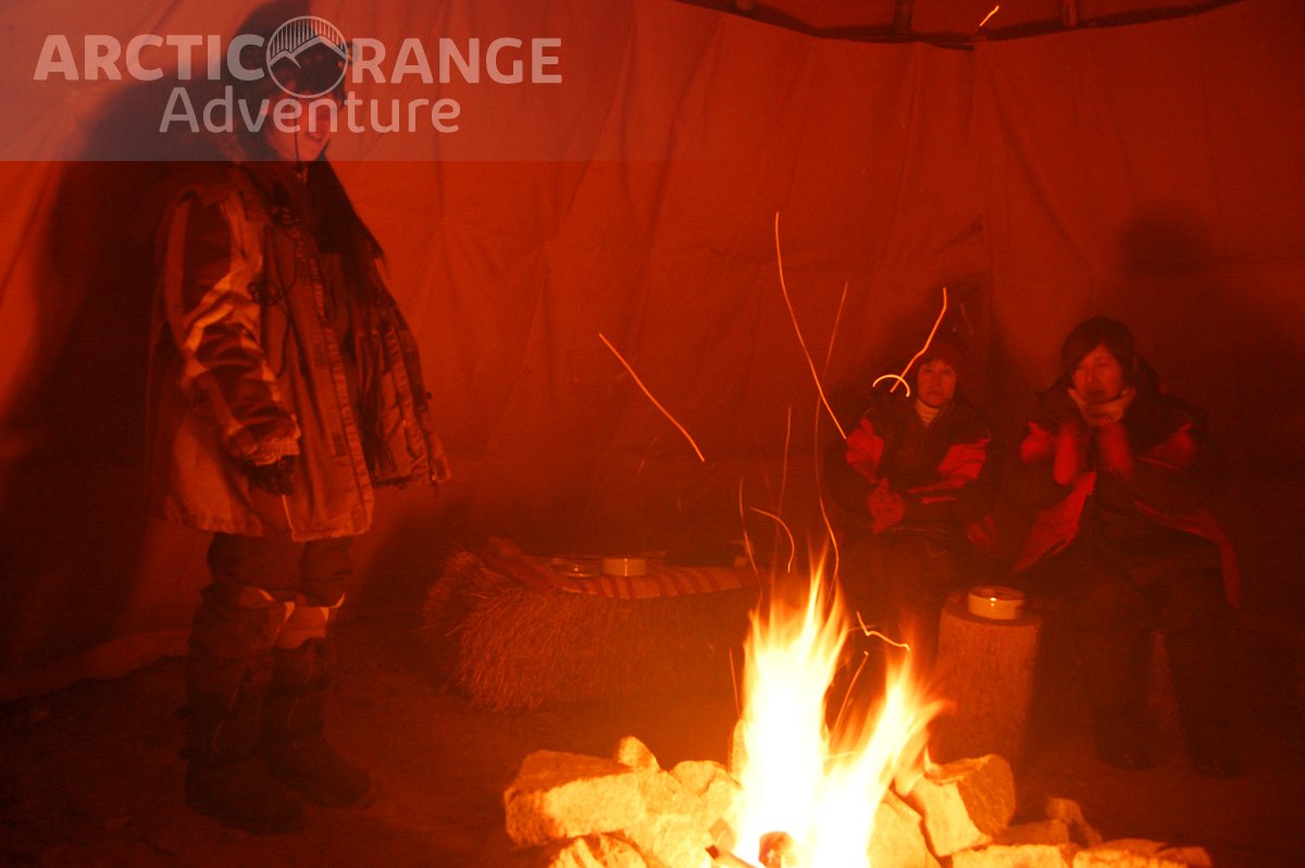 Sitting around the campfire in the Tippi | Arctic Range Adventure