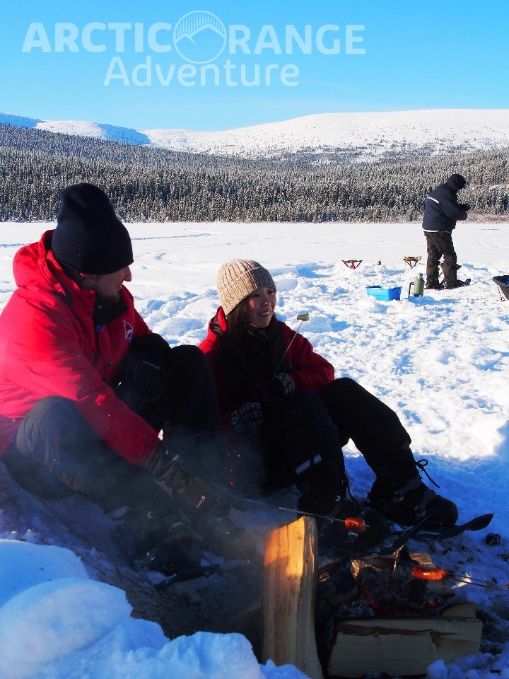 enjoying a snack around the campfire | Arctic Range Adventure