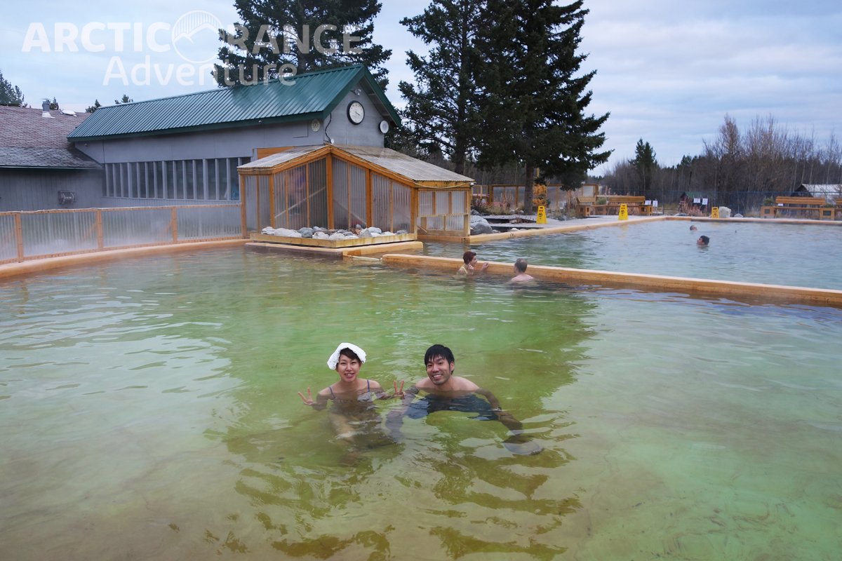 Guest enjoying the hot springs | Arctic Range Adventure